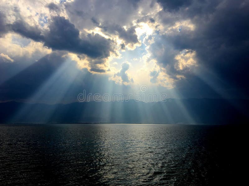 Sunrays Penetrate Through Clouds In The Beautiful Blue Sky Stock Image ...
