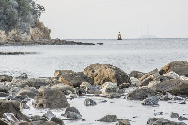 Sea and factory stock photo. Image of rocks, landscape - 79379588