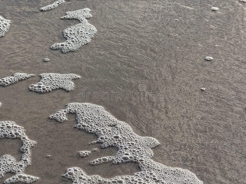 Sea Foam Pattern in the Water Over Sand Stock Photo - Image of ...