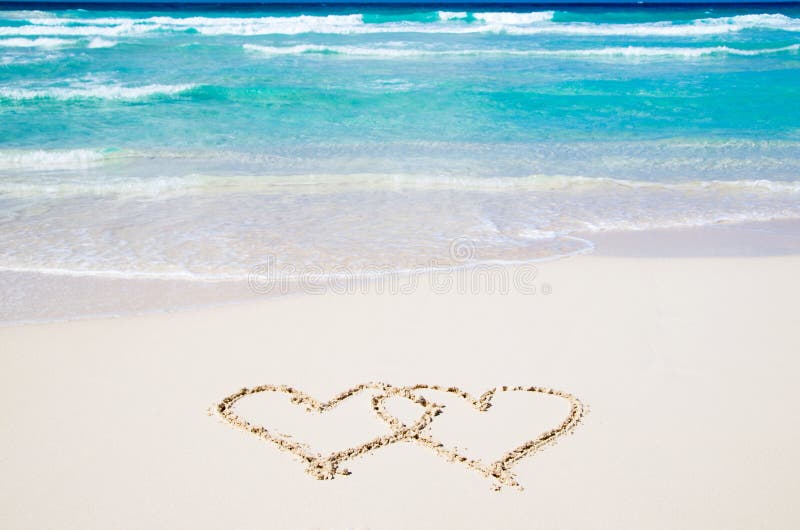 Hearts drawn in the sand stock photo. Image of design - 260762416