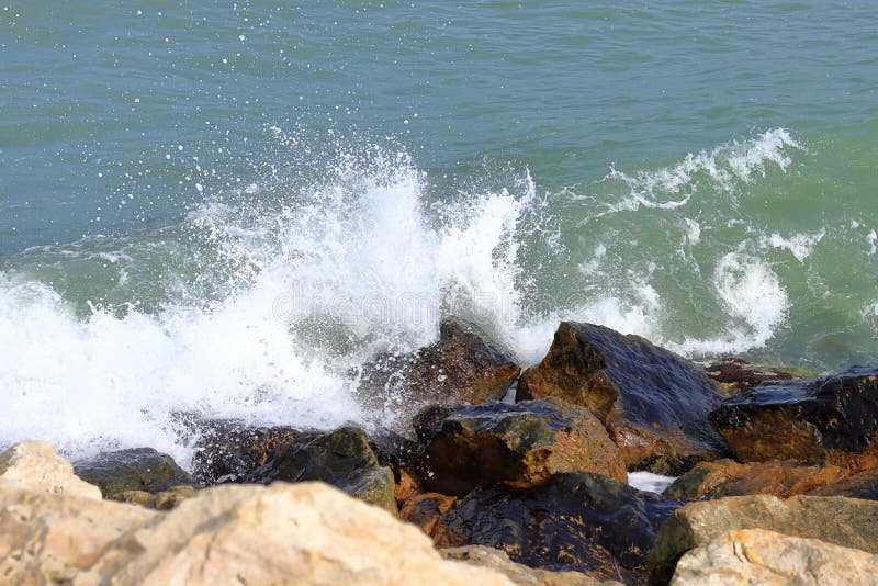 The sea hitting a pier stock photo. Image of beach, rock - 267617816