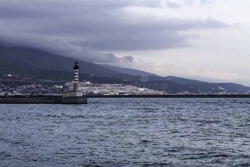 The Sea and the Lighthouse Standing at the Exit from the Port Against ...