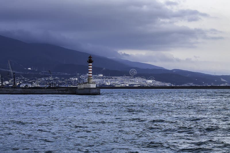The Sea and the Lighthouse Standing at the Exit from the Port Against ...