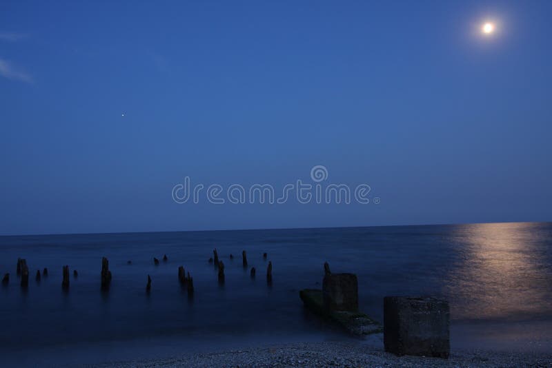 Sea at night stock photo. Image of shine, view, poles - 13293698