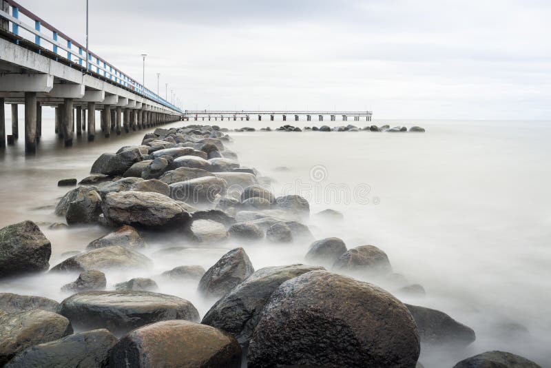 Sea, pier and rocks stock image. Image of jetty, rock - 35968343