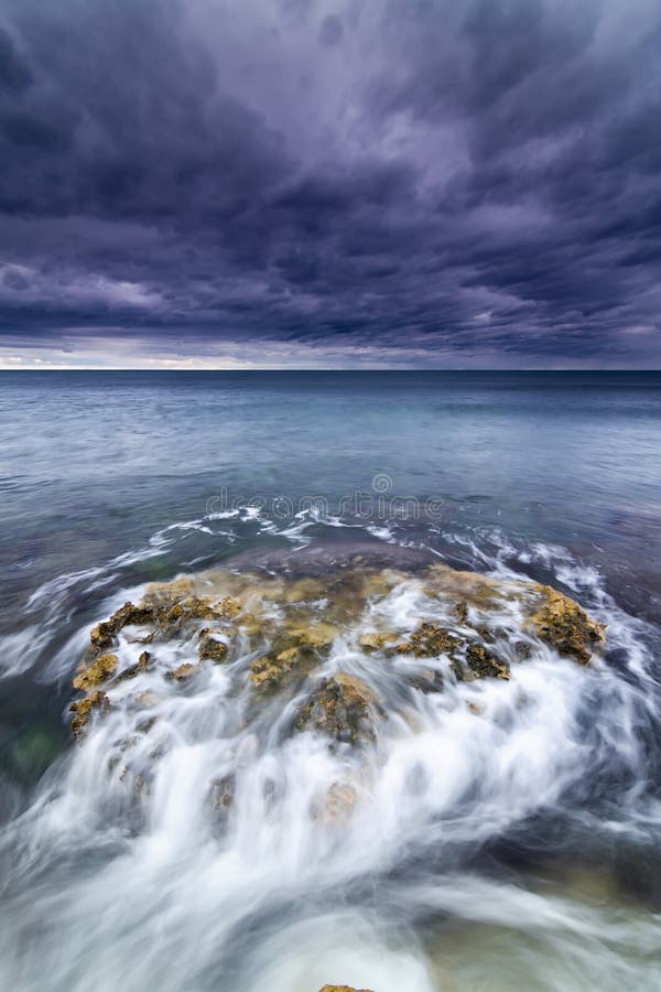 Sea, Rocks and Foam Under a Stormy Sky. Stock Image - Image of clouds ...