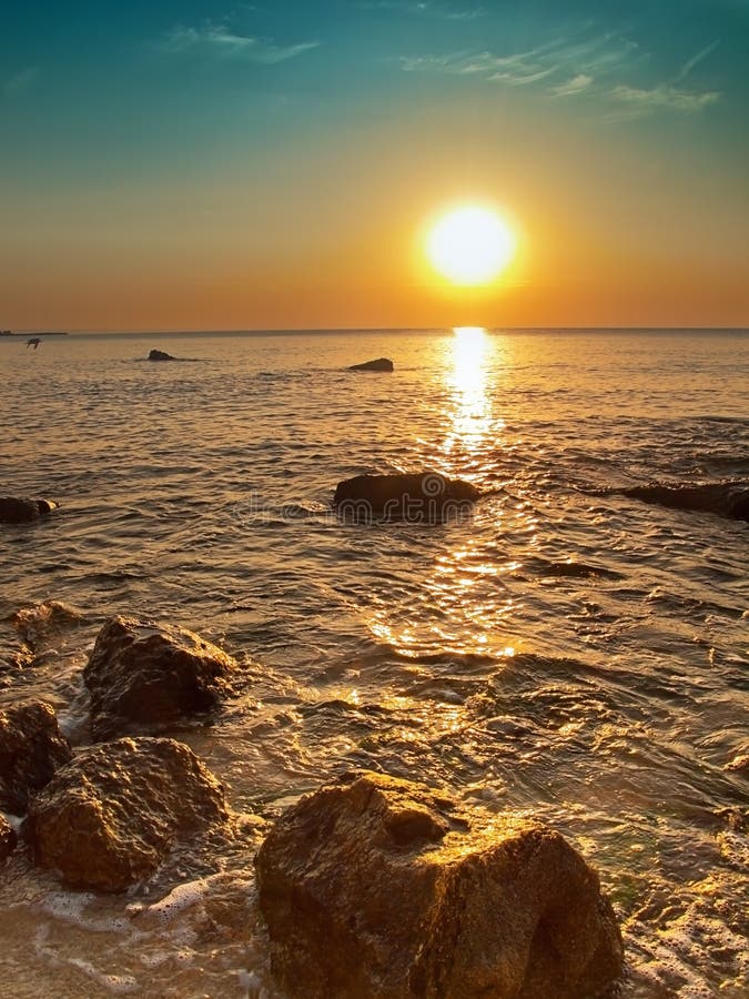 Sea and rocks at sunrise stock image. Image of coast - 15395115