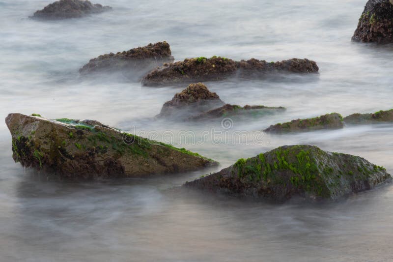 Sea with rocks stock image. Image of sunset, rocky, rocks - 56893425