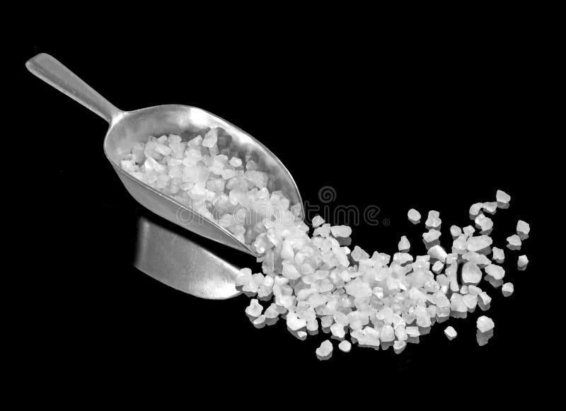 Sea Salt for Use in Cooking, Sprinkled from a Metal Spoon Over Black ...