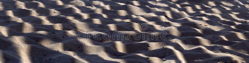 Sea Sand Creates a Wavy Surface. Wavy Shadows Fall on the Illuminated ...