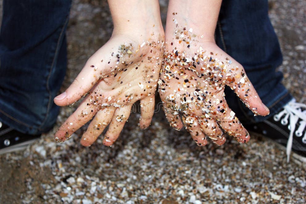 Sea sand on his hands stock photo. Image of clean, grain - 23830268