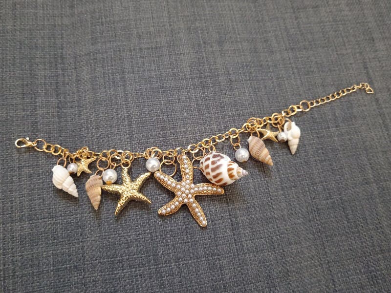 Sea shell bijou bracelet stock photo. Image of thigh - 296525762
