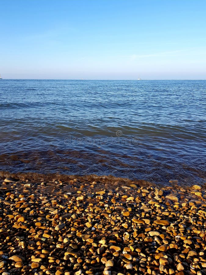 Sea Shore with Pebbles and Blue Sky. Nature Composition. Stock Photo ...