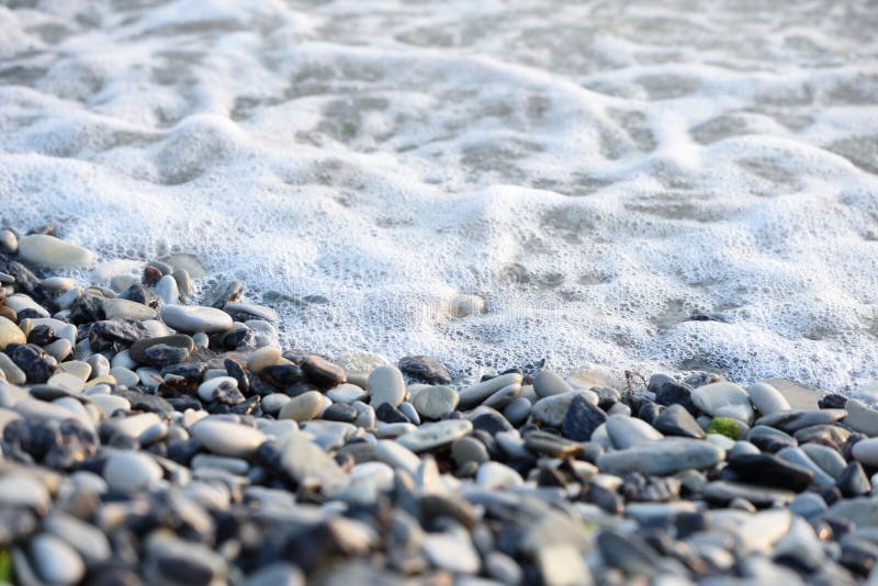 Sea Stone Beach with Small Stones and Small Waves and Foam Stock Image ...