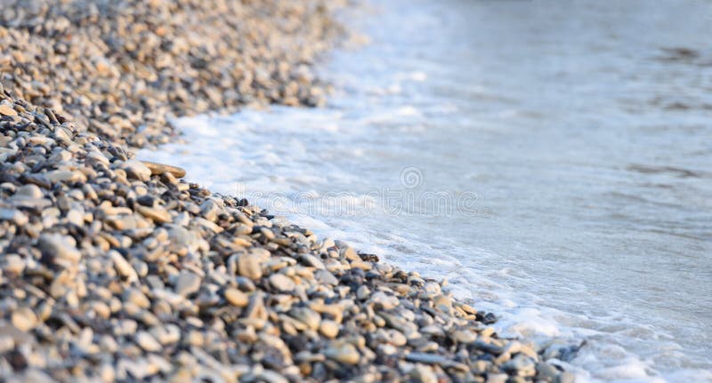 Sea Stone Beach with Small Stones and Small Waves and Foam Stock Photo ...