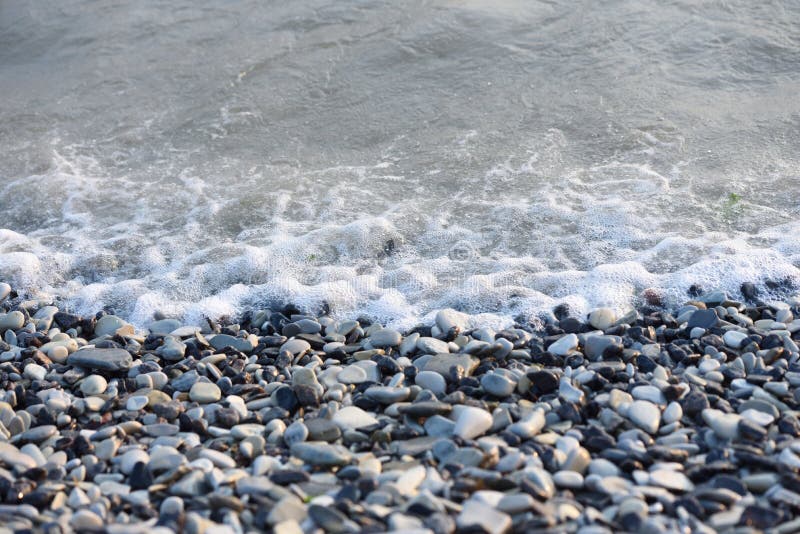 Sea Stone Beach with Small Stones and Small Waves and Foam Stock Image ...