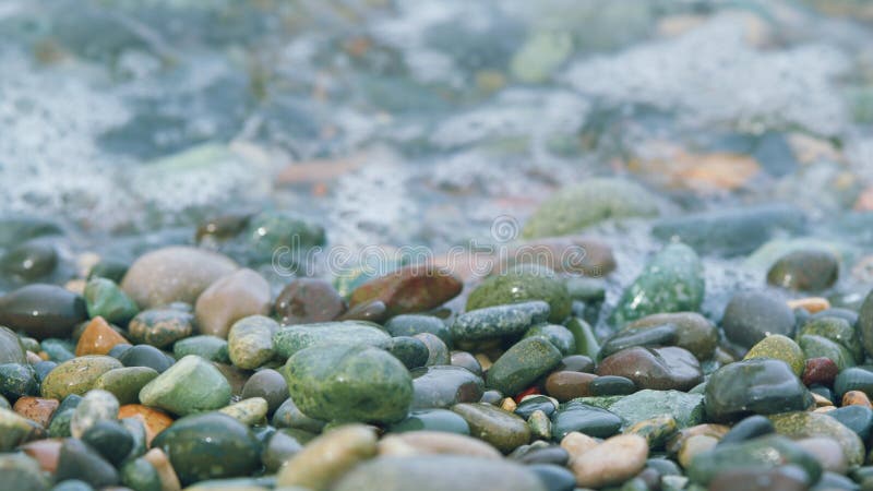 Sea Stones in the Sea Water and Ripples. Pebble Stones by the Sea ...
