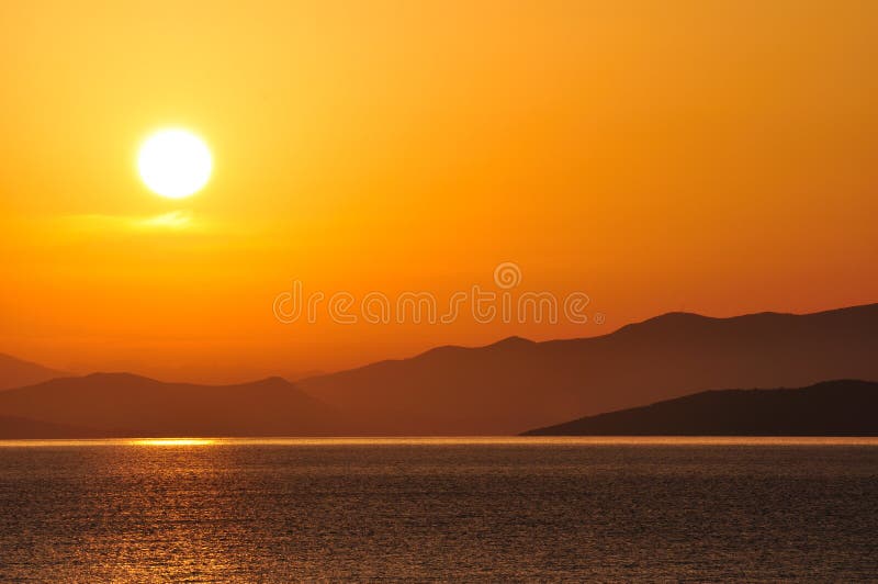 Sea, sunrise and mountains stock image. Image of warm - 19419817
