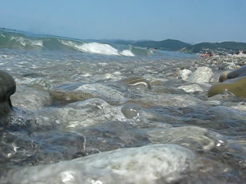 Sea Surf Covers Camera Lying on Stones on Stock Video - Video of liquid ...