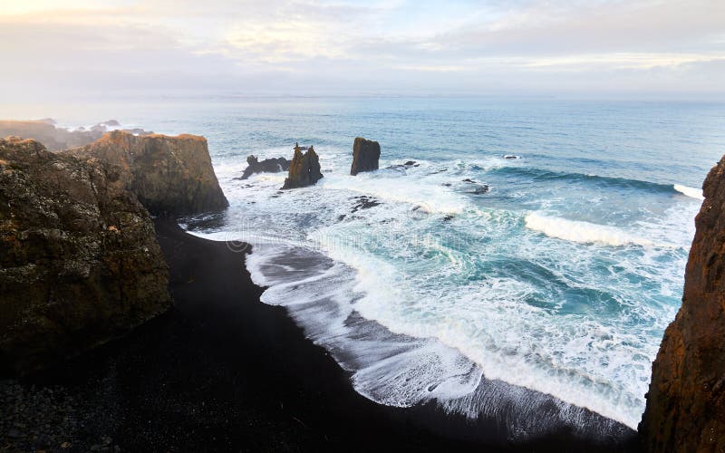 Sea Surrounded by Rocks Under the Sunlight and a Cloudy Sky in Iceland ...