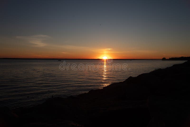 Sea Surrounded by Stones during Beautiful Sunset with the Sun ...
