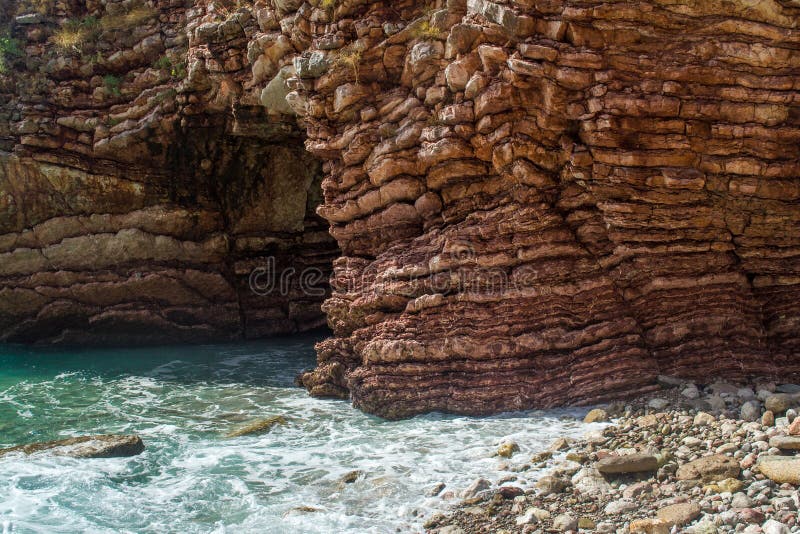 The Sea View. Waves Break on the Stone Shore. Rock and Layered Stone ...