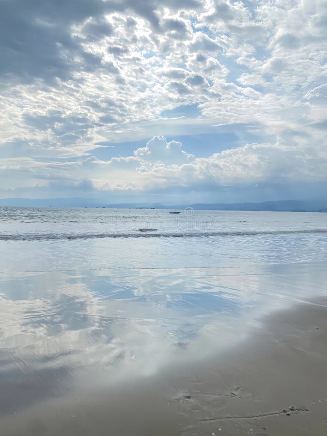 The Sea Was Receding with Bright Blue Clouds Above Stock Photo - Image ...