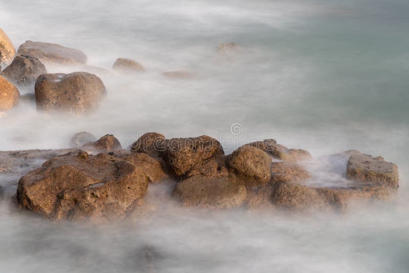 Sea washing over rocks stock image. Image of natural - 171614371