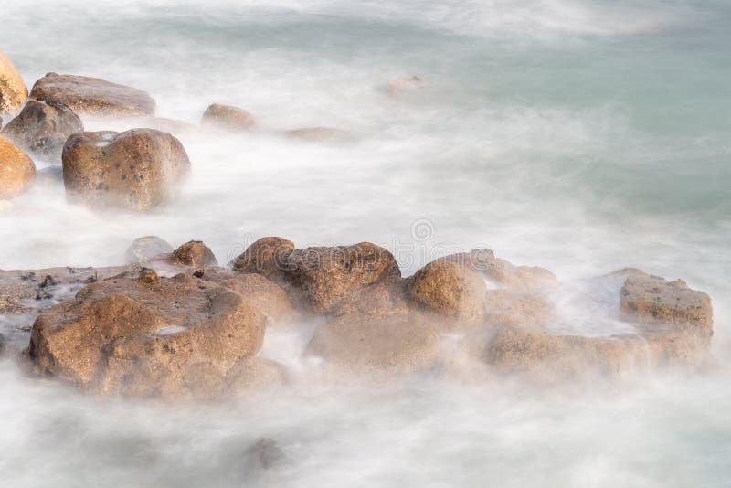 Sea washing over rocks stock photo. Image of nature - 189967652