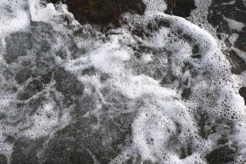 Sea Water Covering Dark Beach Rocks Stock Photo - Image of nature ...