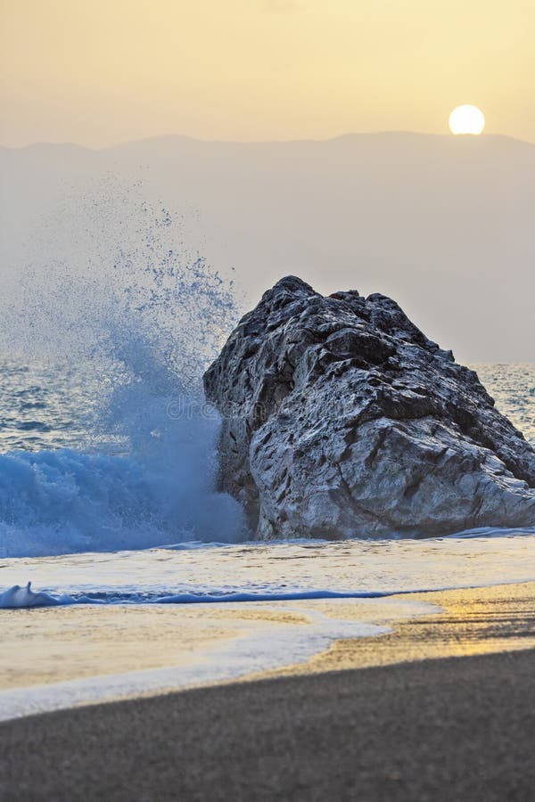 Sea Wave Beating with Force Against the Rock at Sunset Stock Image ...