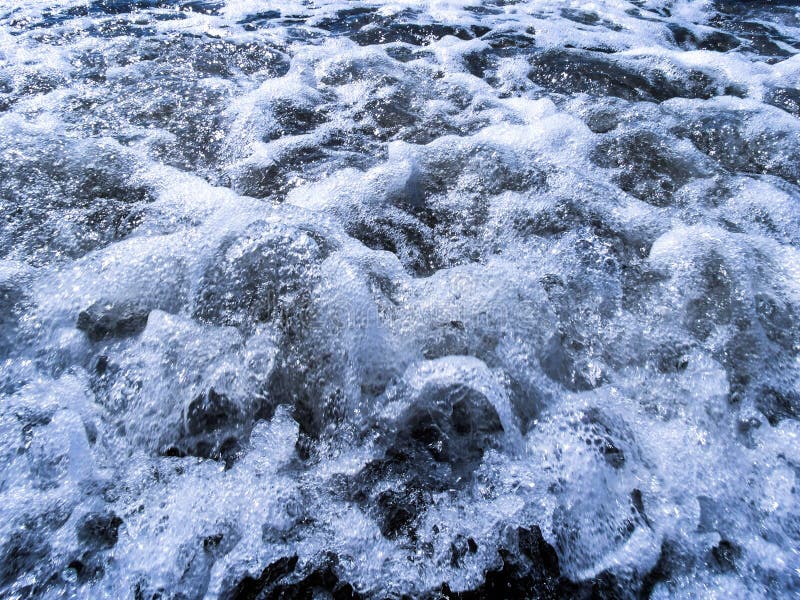 Wave Foaming on the Sand. Closeup of Sea Waves with White Foam on the ...