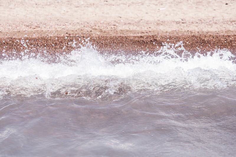 Sea wave and pebble beach stock photo. Image of rock - 98831150