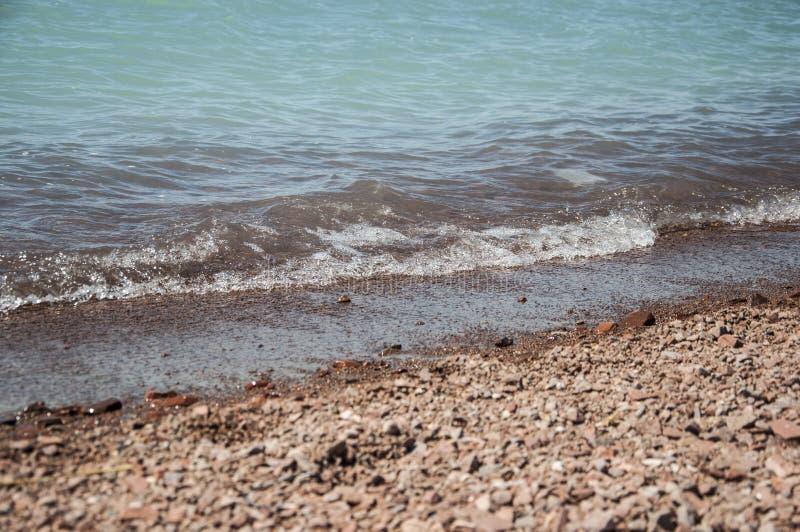 Sea wave and pebble beach stock image. Image of blue - 98830707