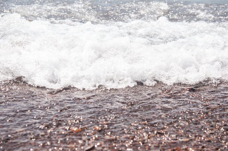 Sea wave and pebble beach stock photo. Image of nature - 98831184