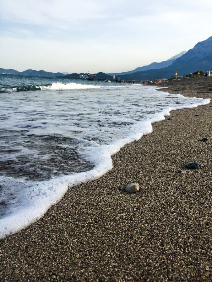 Sea wave on pebbled beach stock image. Image of lapping - 128248229