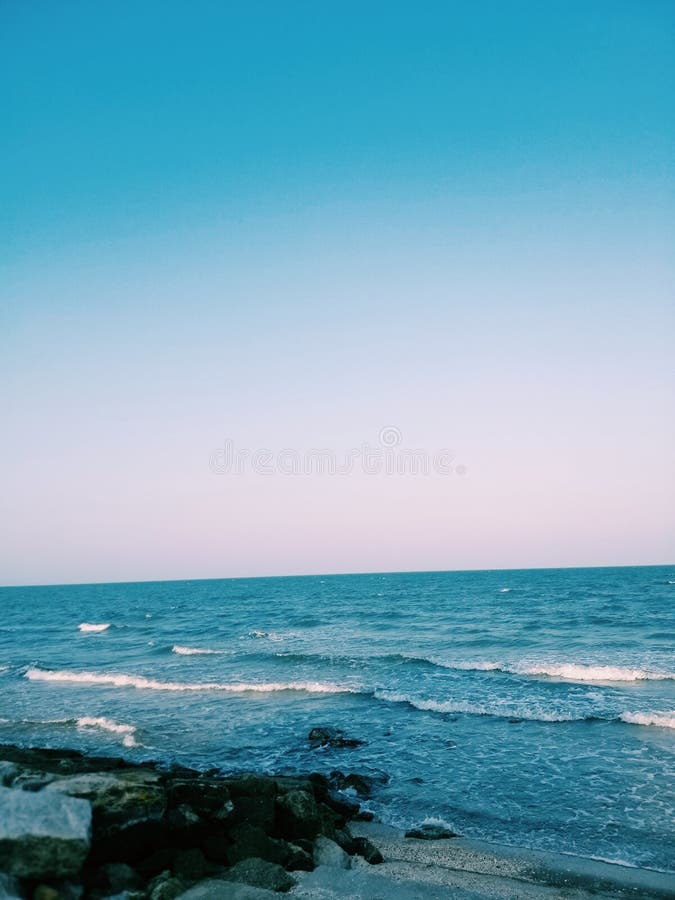 Sea Wave with Blue Sea and Clearly Sky. Evening Light. Rock Beach Stock ...