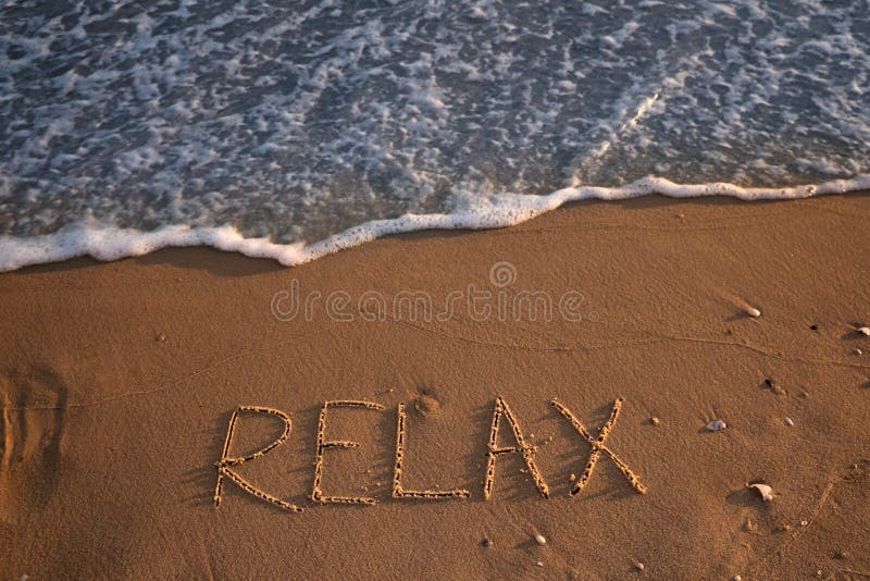 Sea Wave Rolling Onto Sandy Beach with Written Word Relax, Above View ...