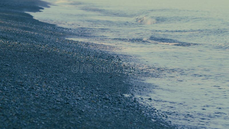 Sea Waves Break on Pebble Beach. Wave Motion on the Shoreline with Foam ...