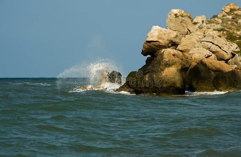 Sea Waves Break into Small Splashes on the Coastal Rocks. Stock Photo ...