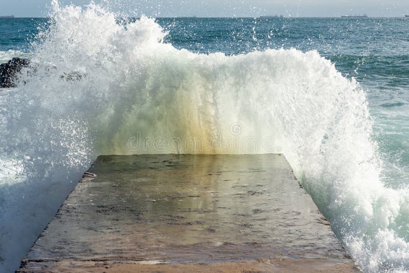 Sea Waves Hit the Cement Pier on a Beach. Wild Nature Stock Photo ...
