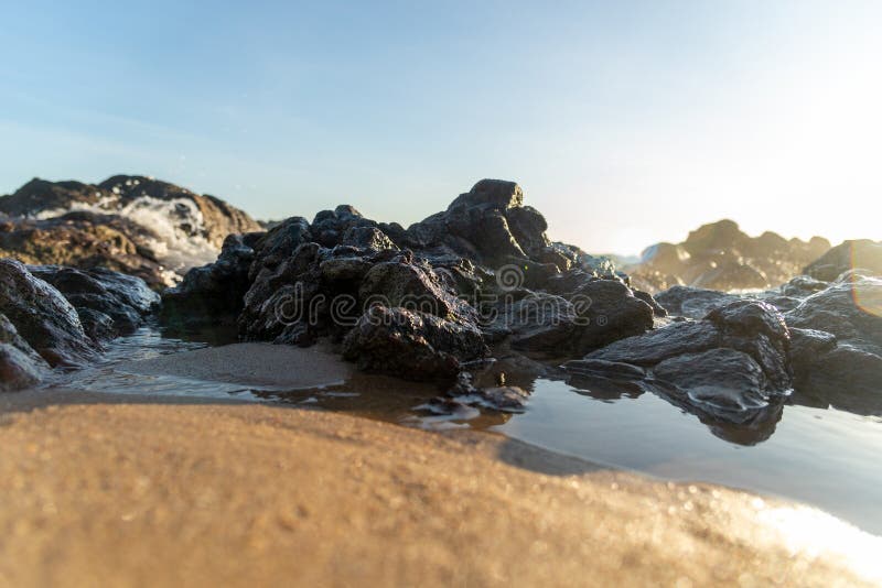 Sea Waves Lapping Gently on the Dark Rocks of the Beach Stock Photo ...