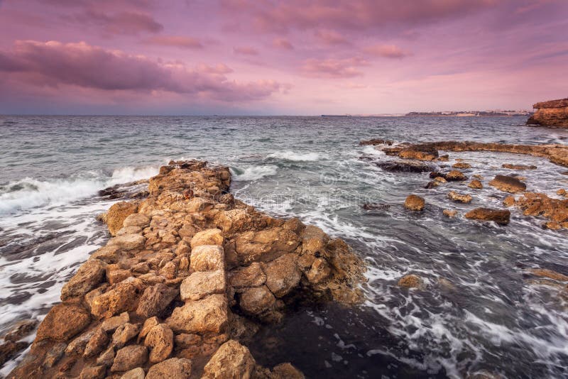 Sea Waves with Rocks on the Beach at Sunset Stock Image - Image of ...