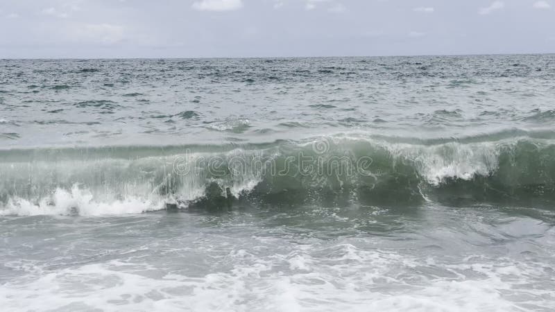Sea Waves Rolling Towards the Shore at Sunset, with Cloudy Dusk Sky in ...