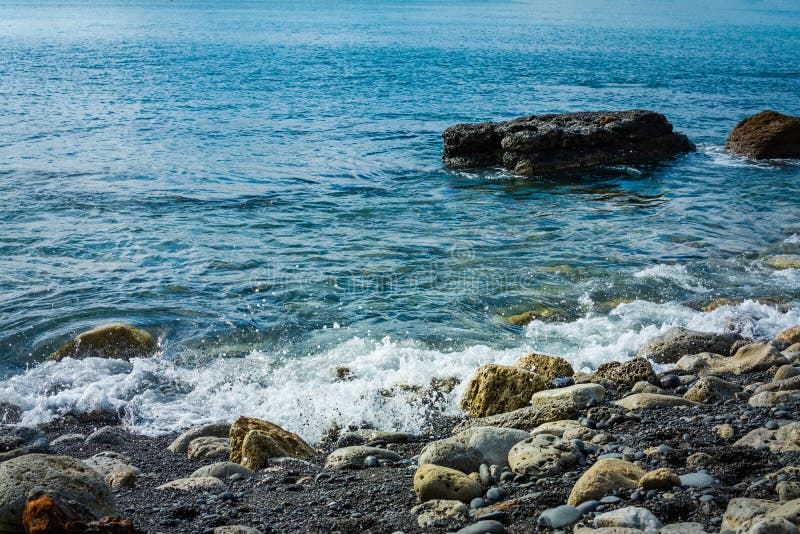 Sea Waves Splashes Around Rocks on a Pebble Beach. Seascape Stock Photo ...