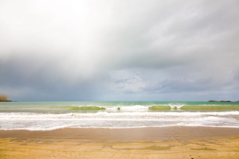 Sea Waves Splashing Over the Shore with Stormy Clouds in the Background ...