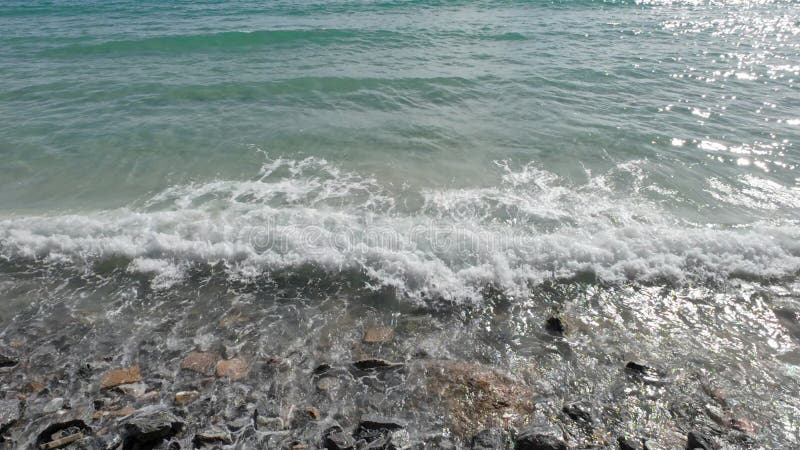 Sea Waves at Sunset. Sea Waves Crash on the Rocks of the Coast Creating ...