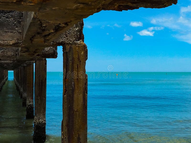 Sea and Weathered Bridge Columns Stock Photo - Image of beach, blue ...