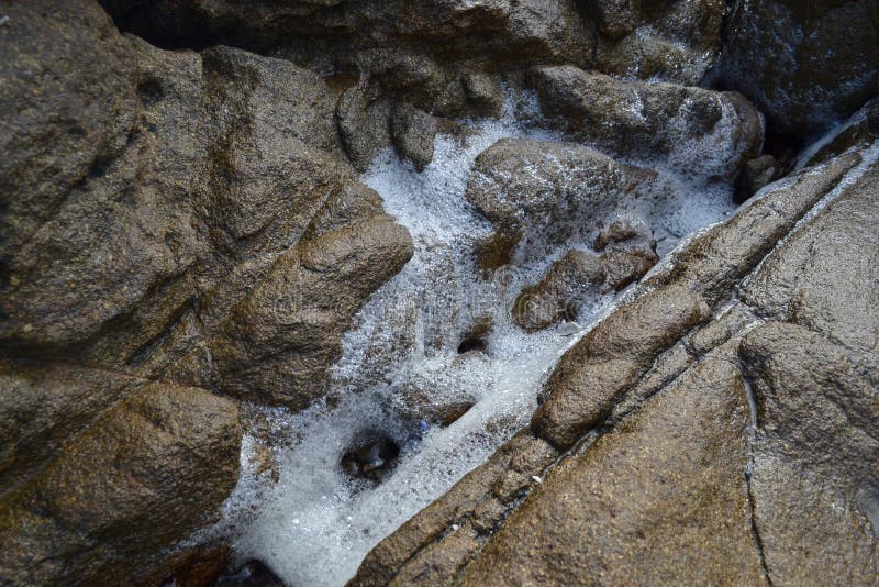 Seafoam on rocks stock image. Image of shell, rockpool - 47293615