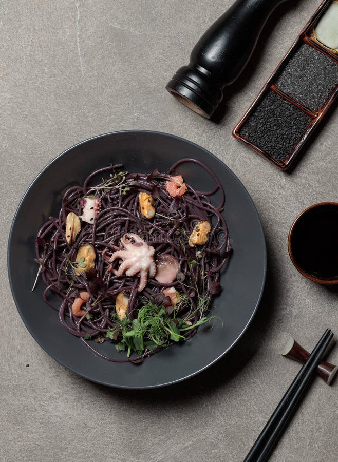 Black Cuttlefish Ink Paste with Seafood. Top View on a Gray Background ...